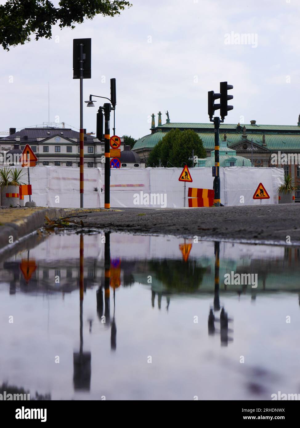 puddle in front of a road work Stock Photo - Alamy