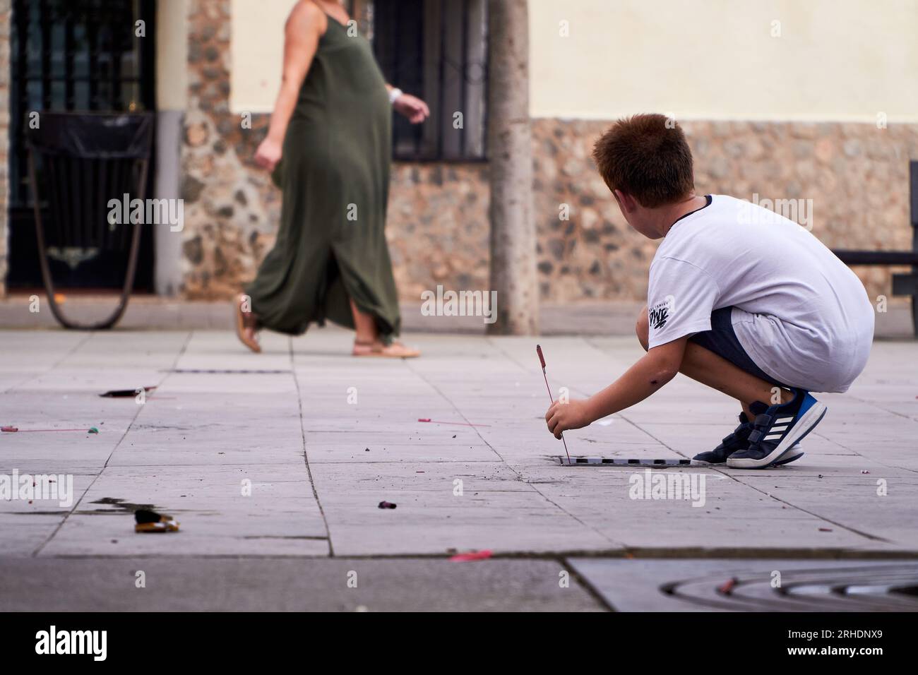 Kid about to burn a firecracker when a pregnant woman passes by on the ...