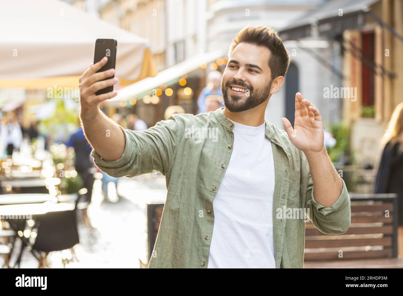 Bearded man blogger taking selfie on smartphone, communicating video ...