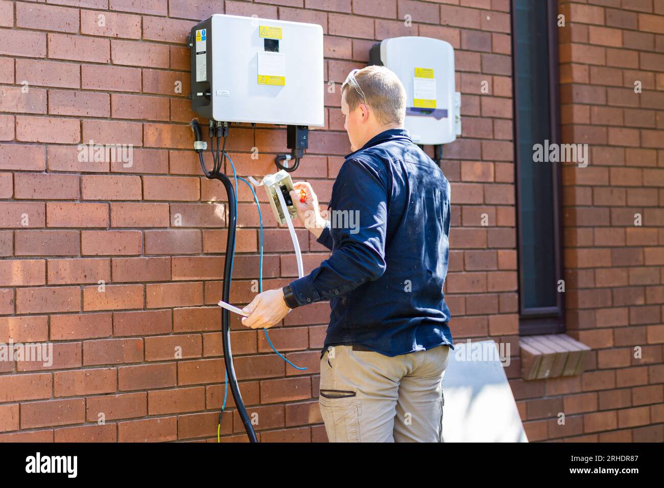 Electrical tradie working as an electrician doing a solar power ...