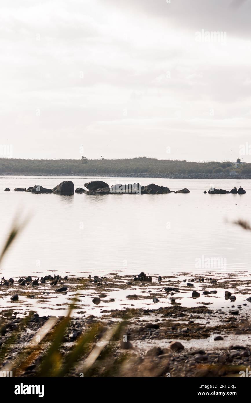 A pile of rocks sat in the Bluff harbour Stock Photo - Alamy
