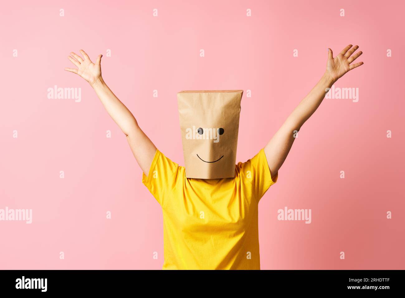 Woman with happy smile on the paper bag on head celebrating success ...