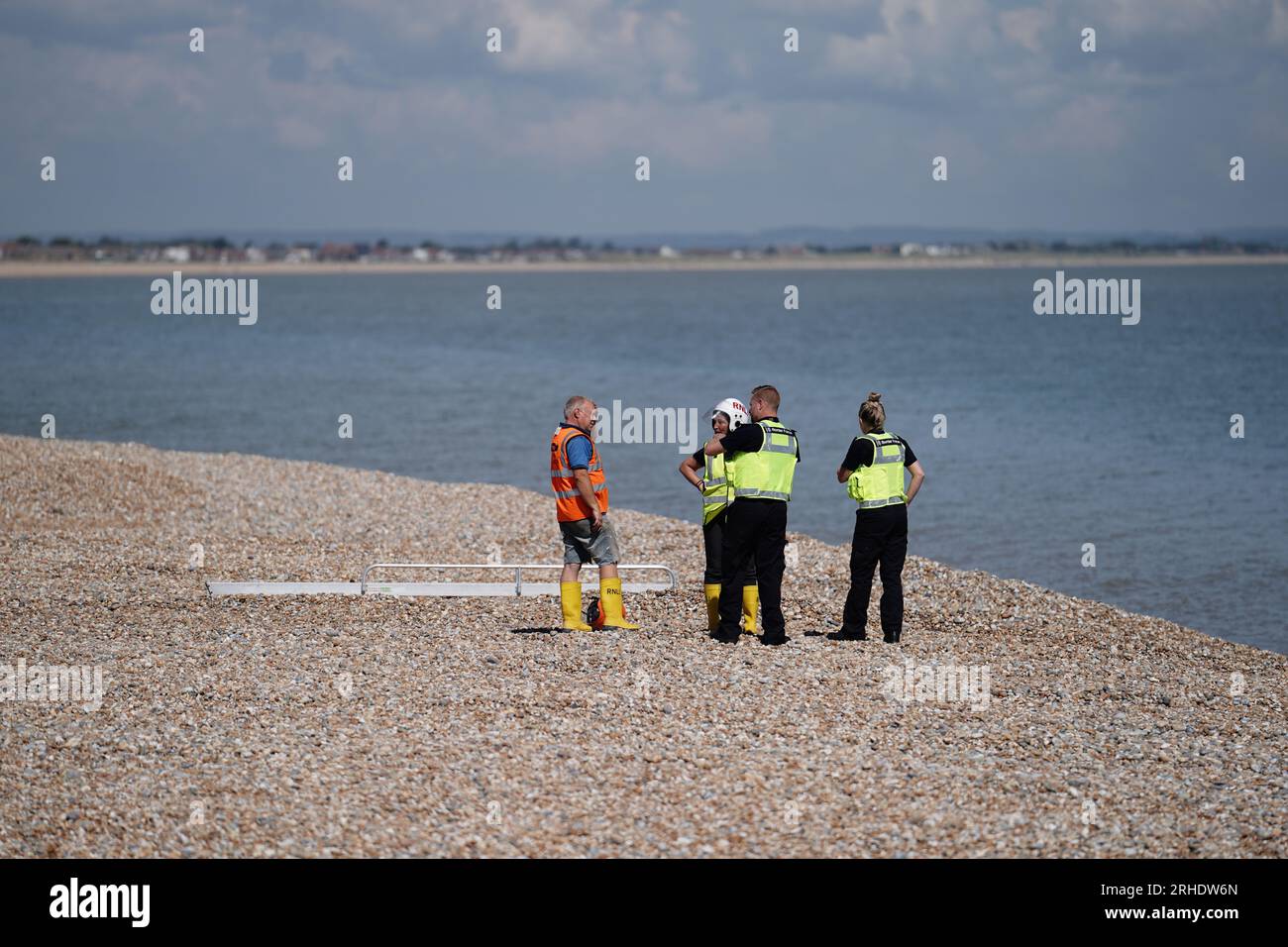 Border Force officers and RNLI staff on Dungeness beach in Kent wait ...