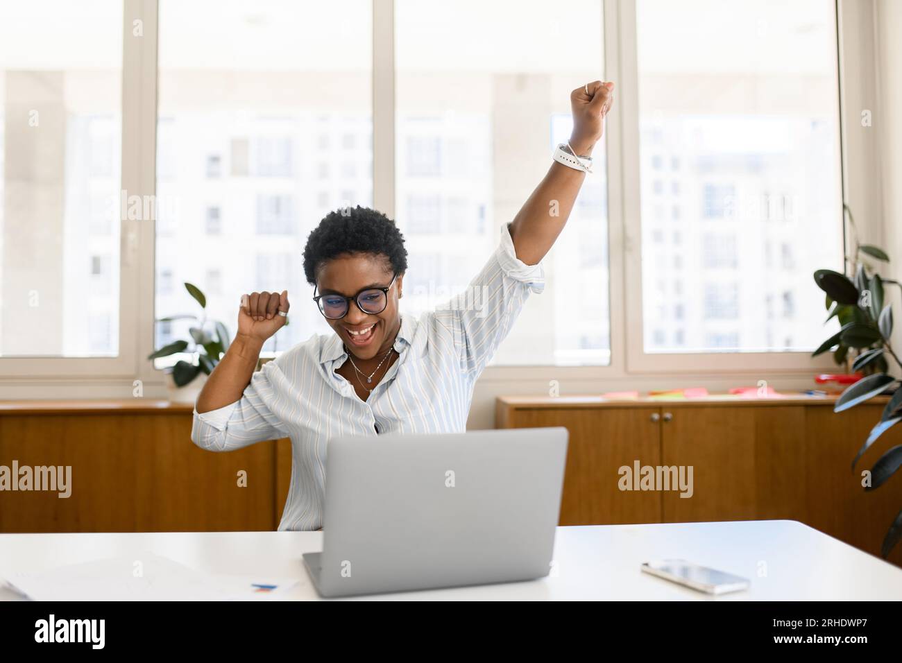 Lucky and happy young african-american female office employee ...