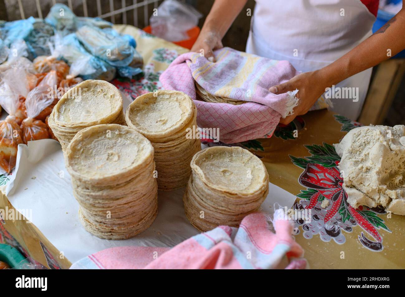 High angle of crop anonymous cook standing near stacked freshly made ...