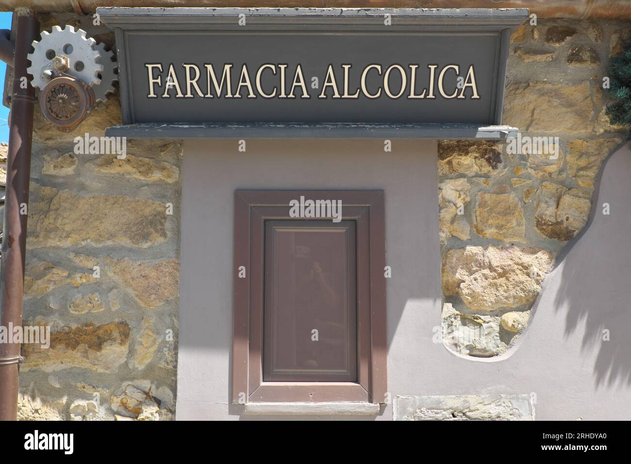 facade with a close window and sign with italian text "FARMACIA ...
