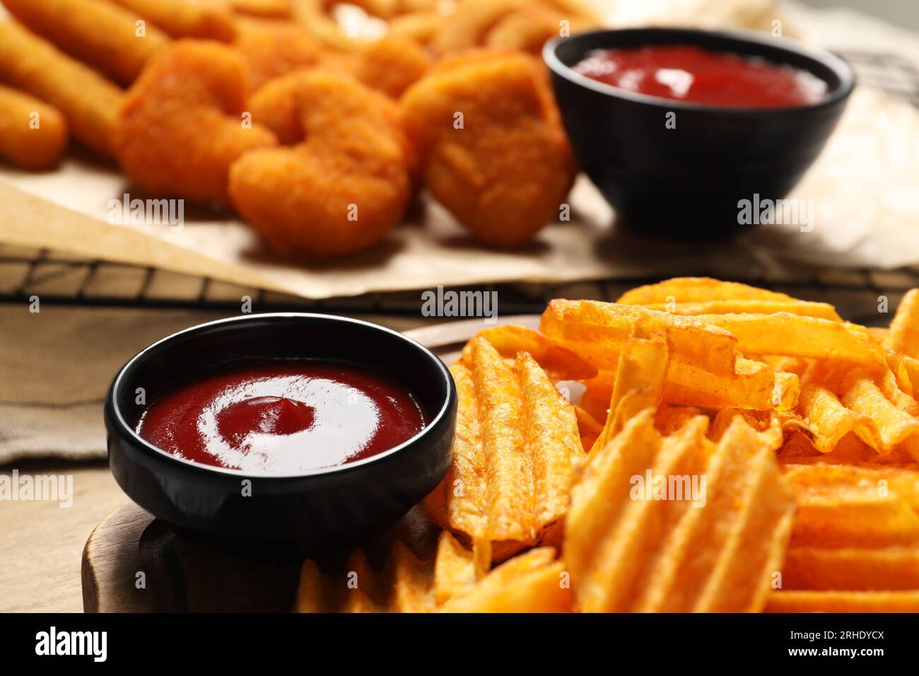 Bowls with tasty ketchup and snacks on table, selective focus Stock ...