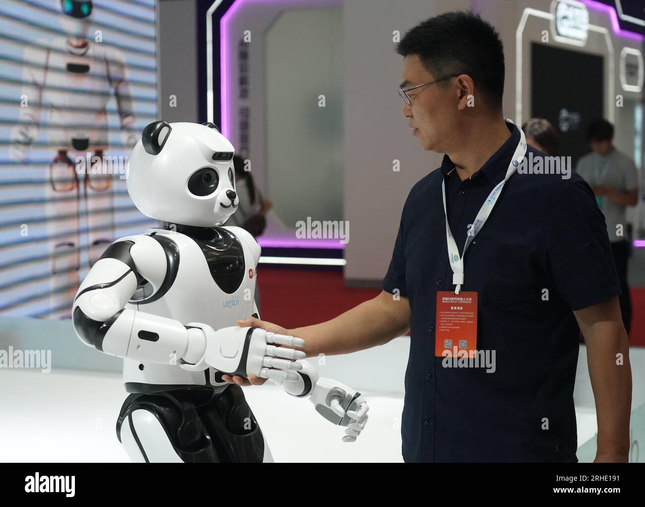 Beijing, China. 16th Aug, 2023. A visitor interacts with a humanoid ...