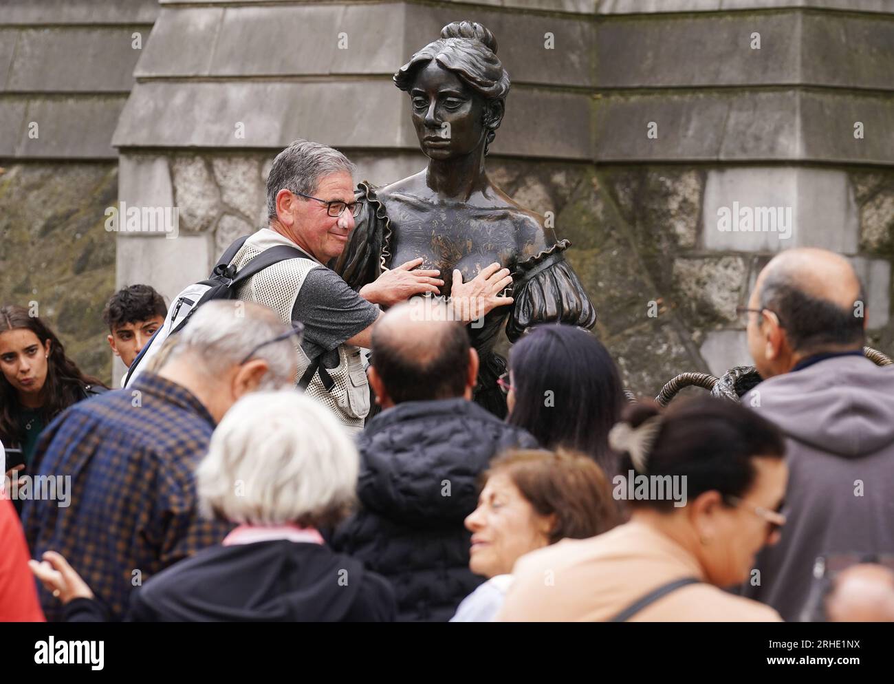 People pose for photographs with the iconic Molly Malone statue in Dublin's city centre after it ...