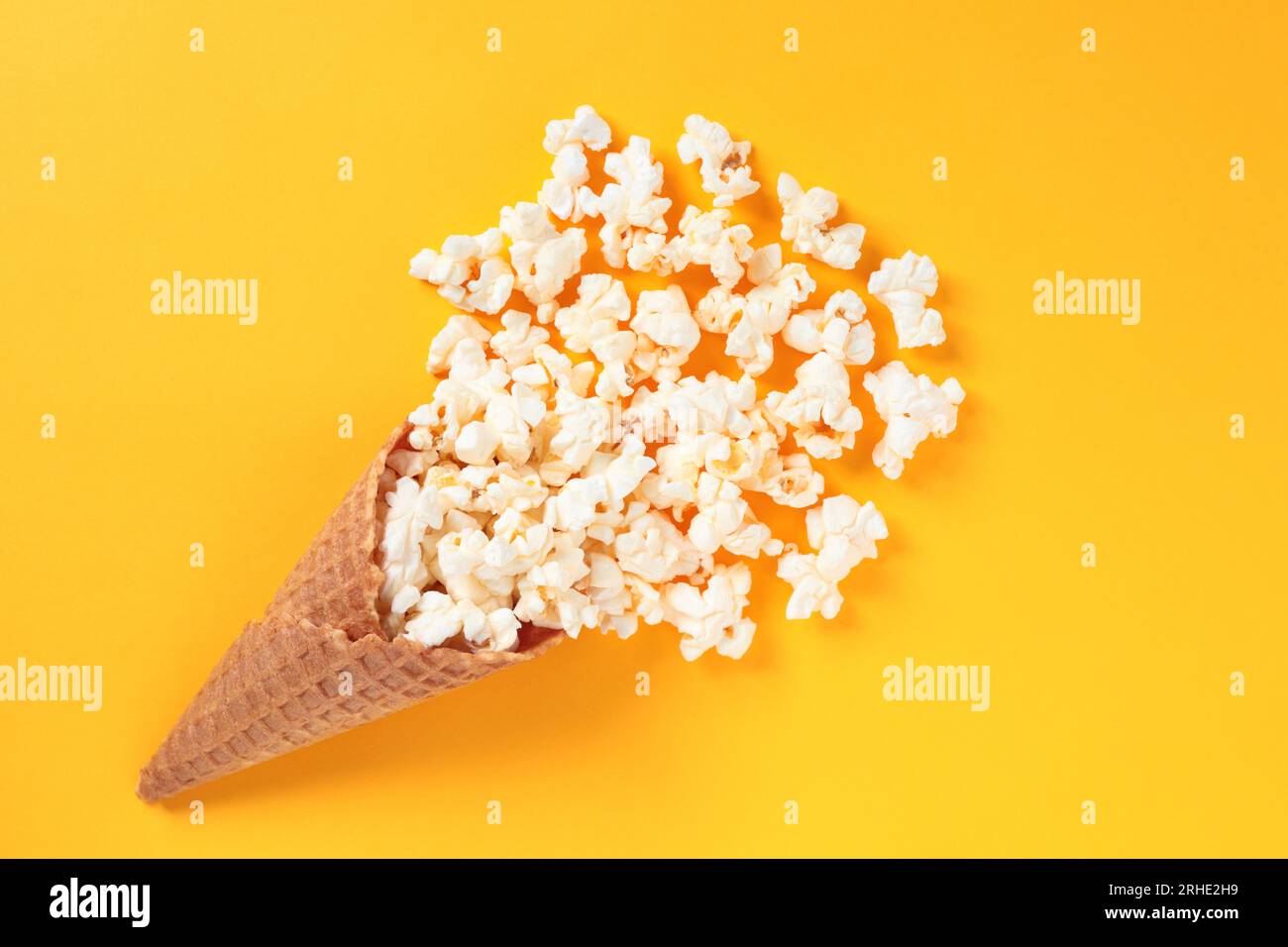 Waffle Cone with Salted Popcorn on yellow background. Snack concept ...