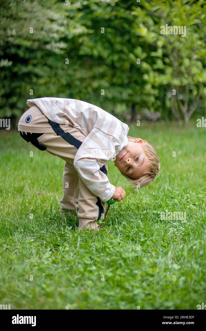 Little preschool child, with funny cloths, making smile face, looking ...