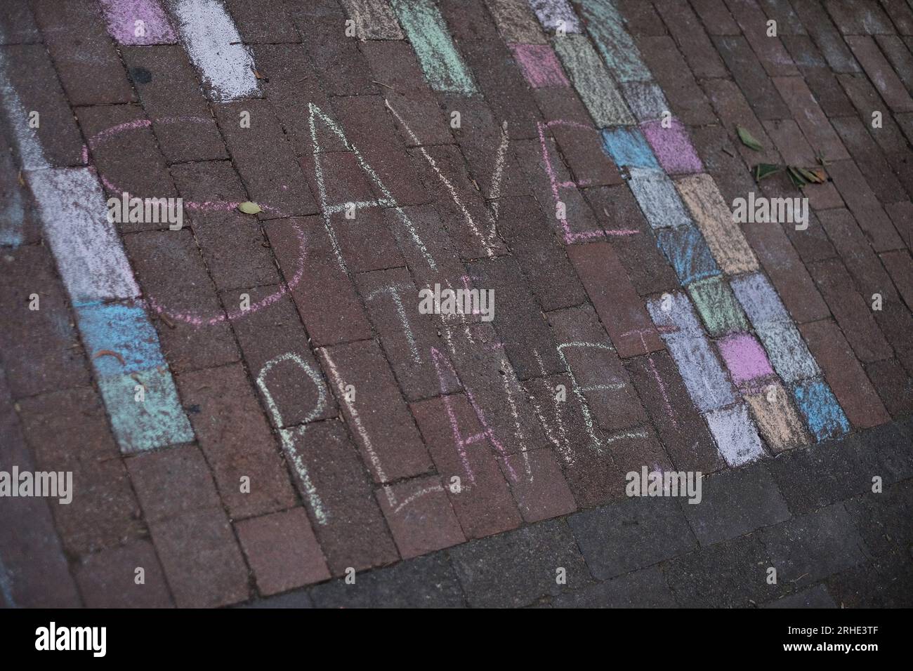 Save The Planet, in Children's Chalk writing on the brick pavement in ...