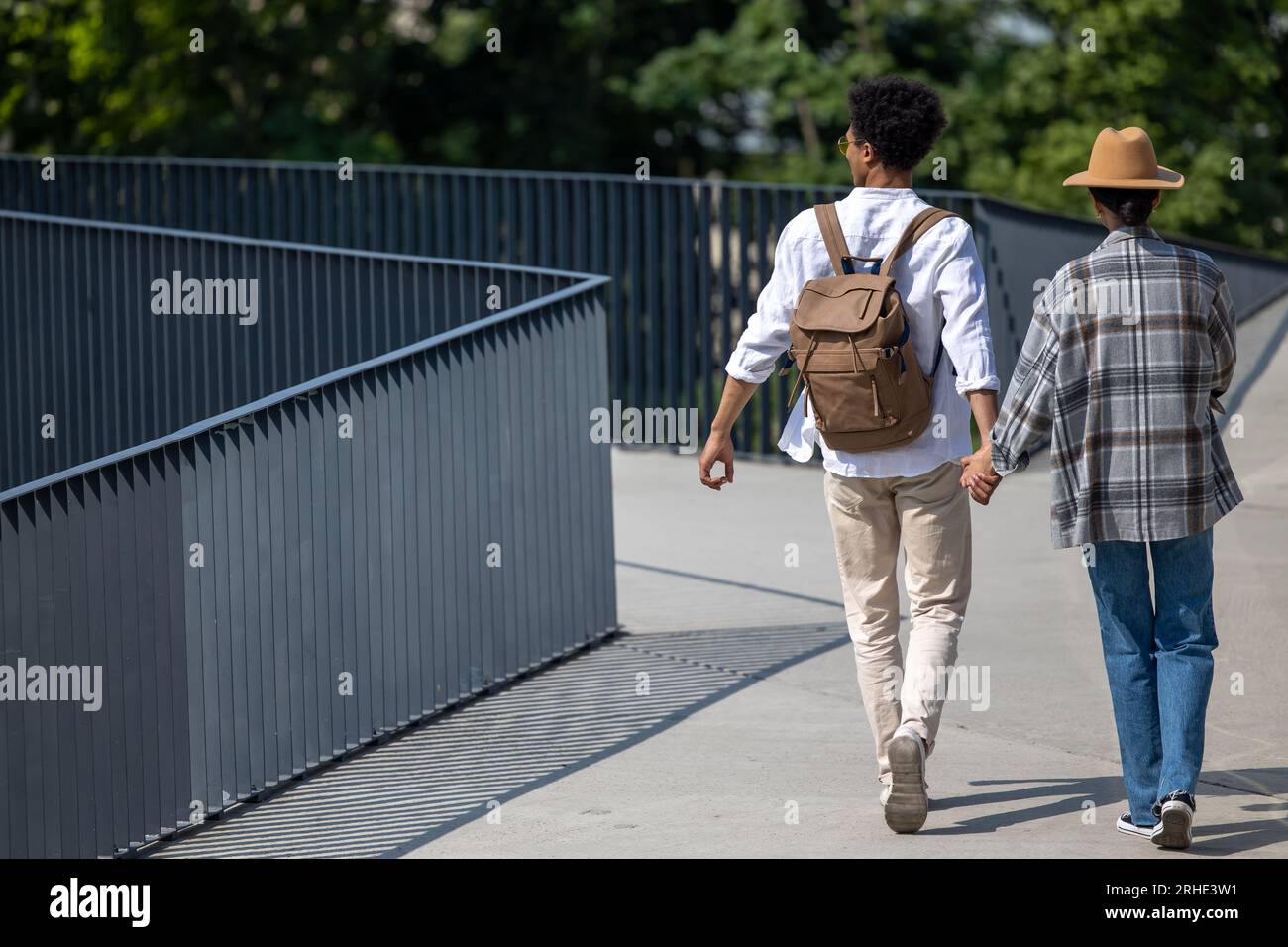 Two young people having a walk around the park Stock Photo - Alamy