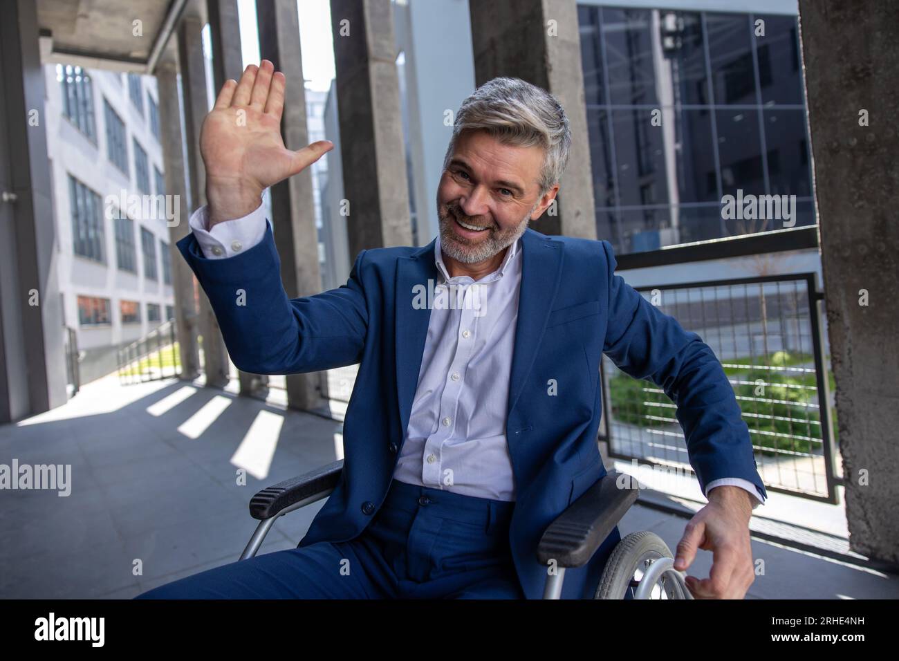 Gray haired disabled man wearing official style suit in wheelchair ...