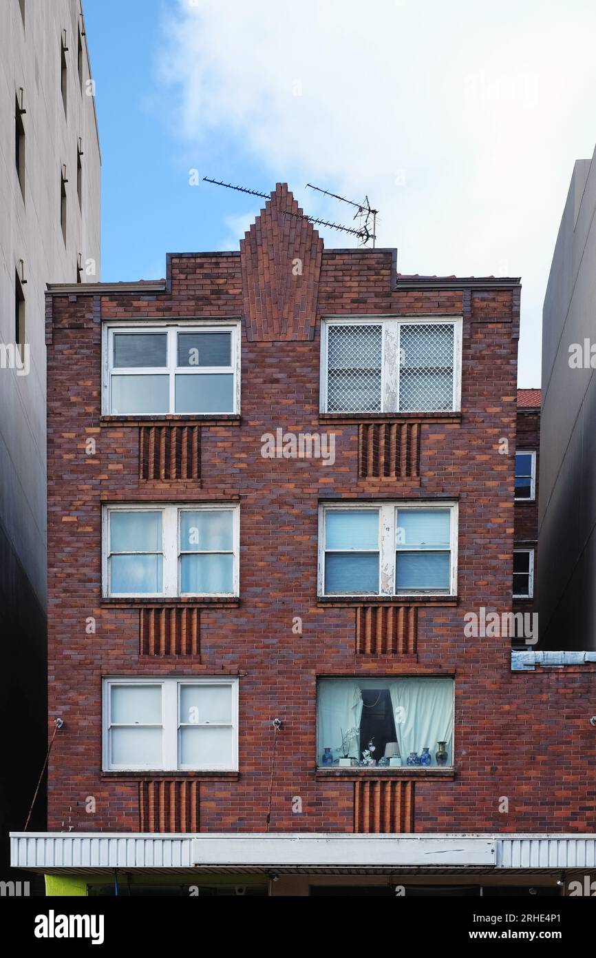 A small 3 story red brick Art Deco apartment building with brick ...