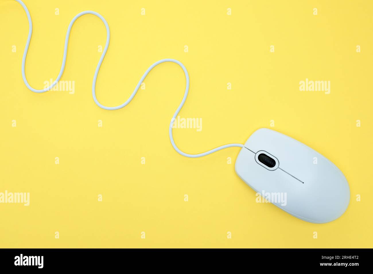 White modern wired computer mouse on yellow background. Computer ...