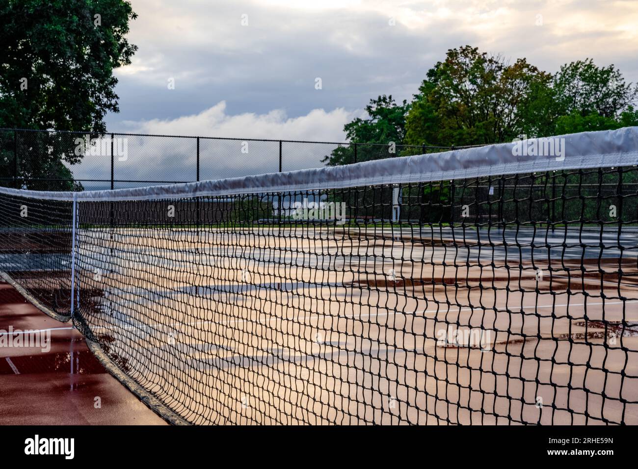 Wet net on a new combined tennis pickleball court Stock Photo - Alamy