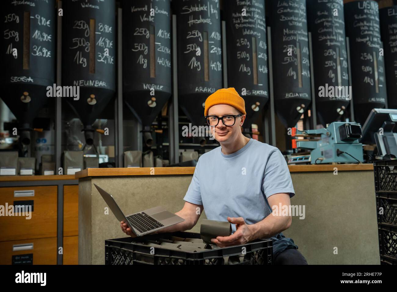 Barista working in coffee shop, accepts new product, checks the amount ...