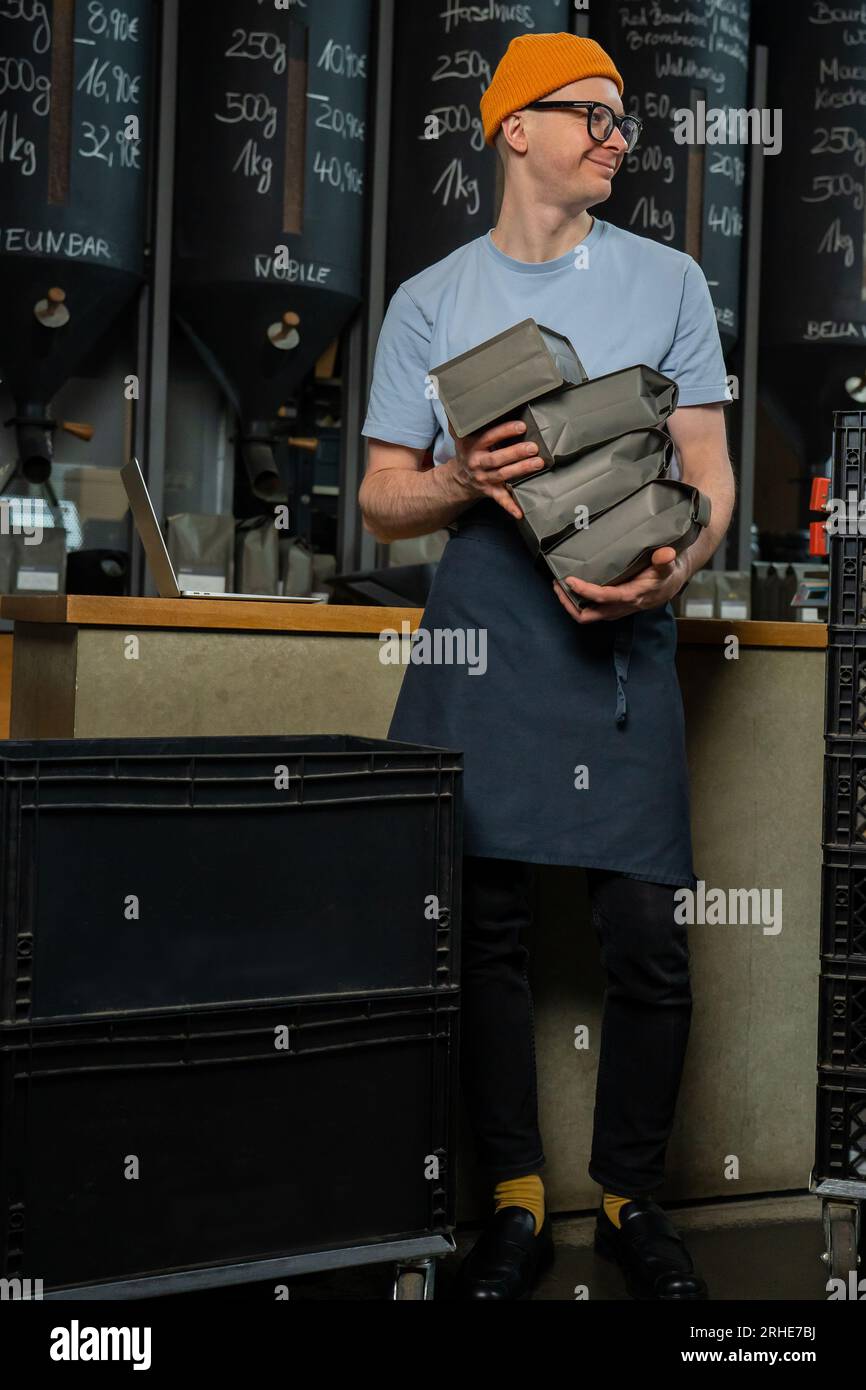 Barista accepts new batch of coffee unpacking boxes, preparing for ...