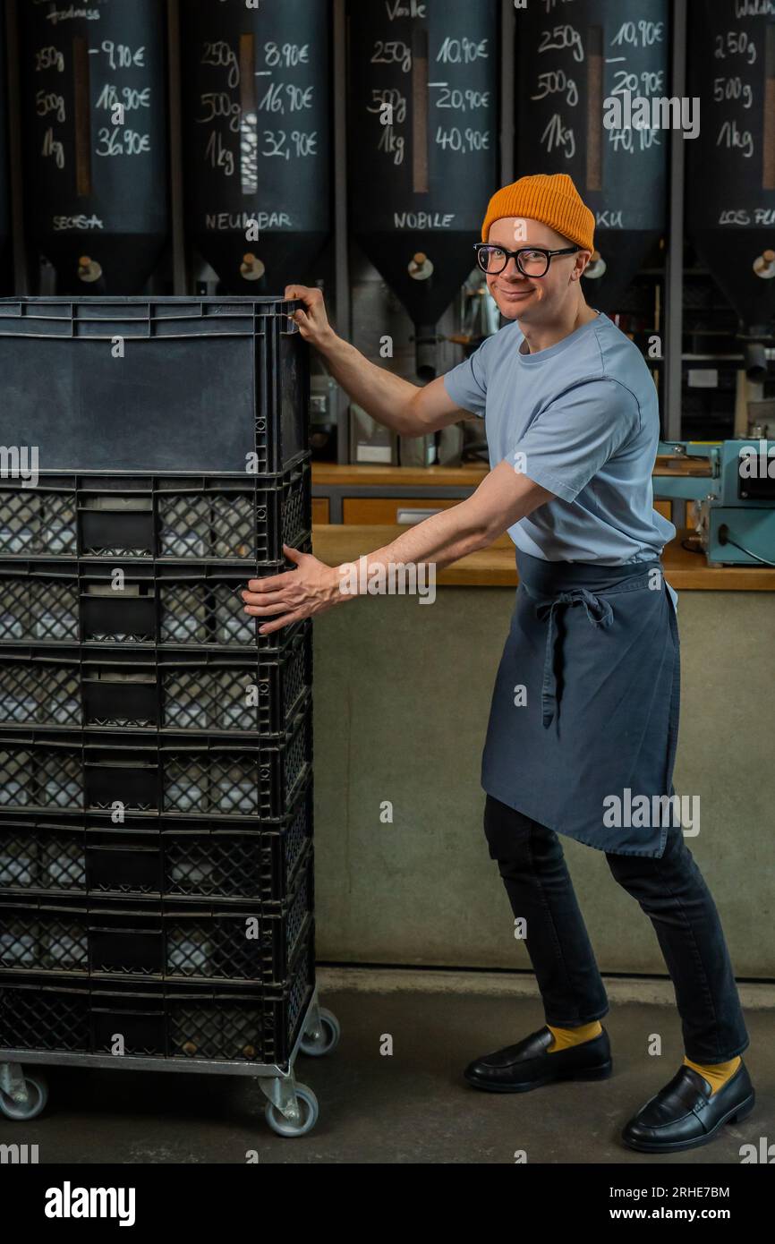 Barista accepts new batch of coffee unpacking boxes, preparing for ...