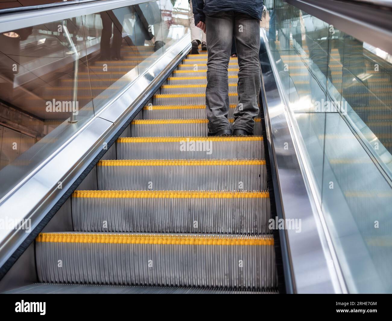 Candid Photography of people standing on a moving escalator going up, taken in Central London in ...
