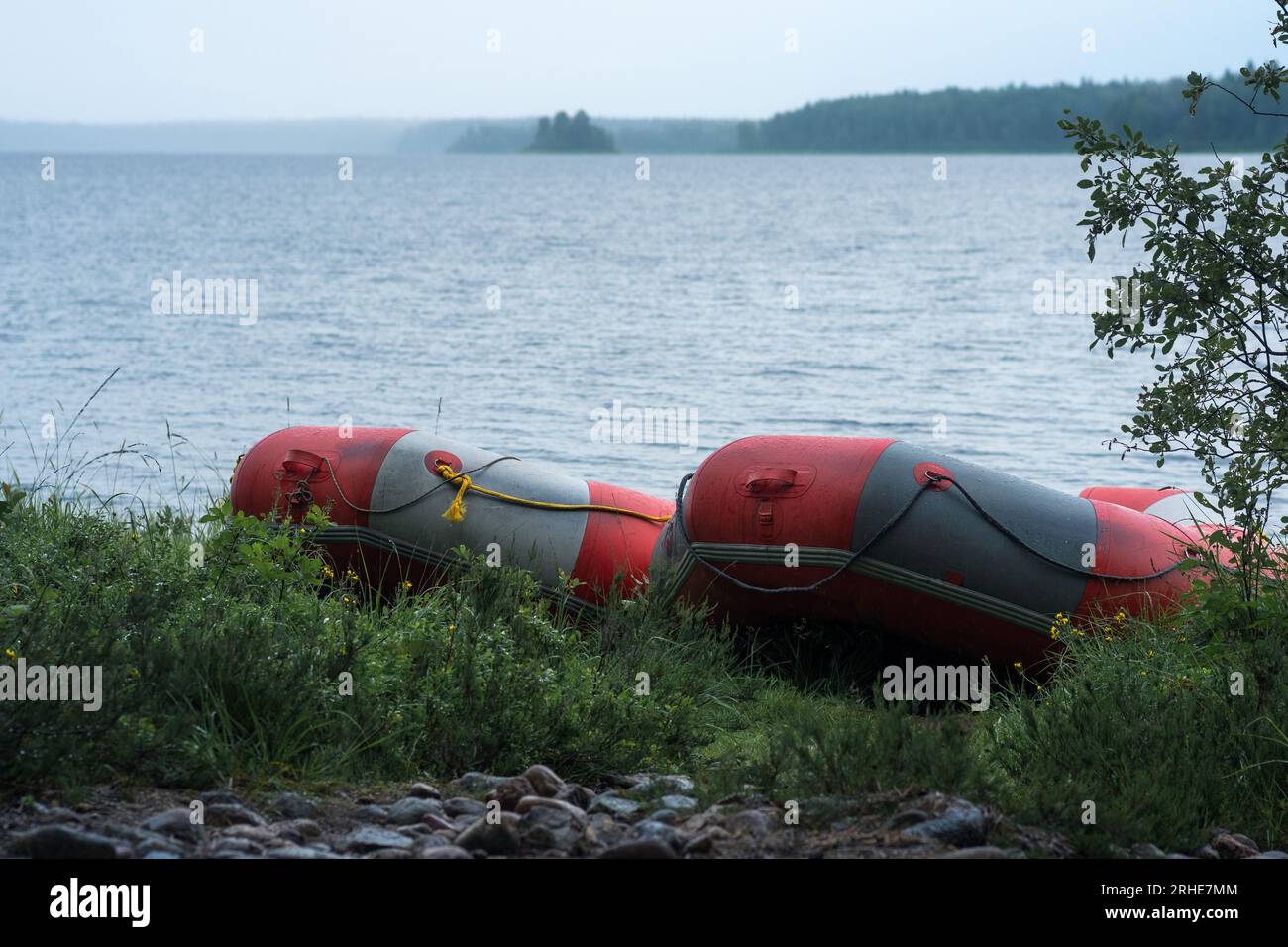 inflatable rafts is moored on the lake shore on a rainy day Stock Photo ...
