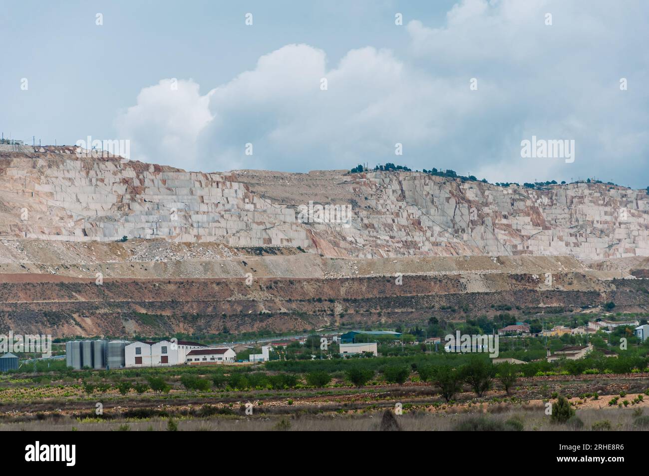 view of an open pit marble quarry showing heavy duty equipment and rock ...