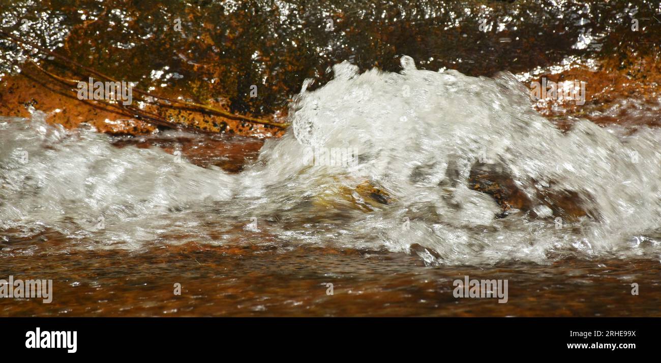 water flowing on the rock and wave splashing in river Stock Photo - Alamy
