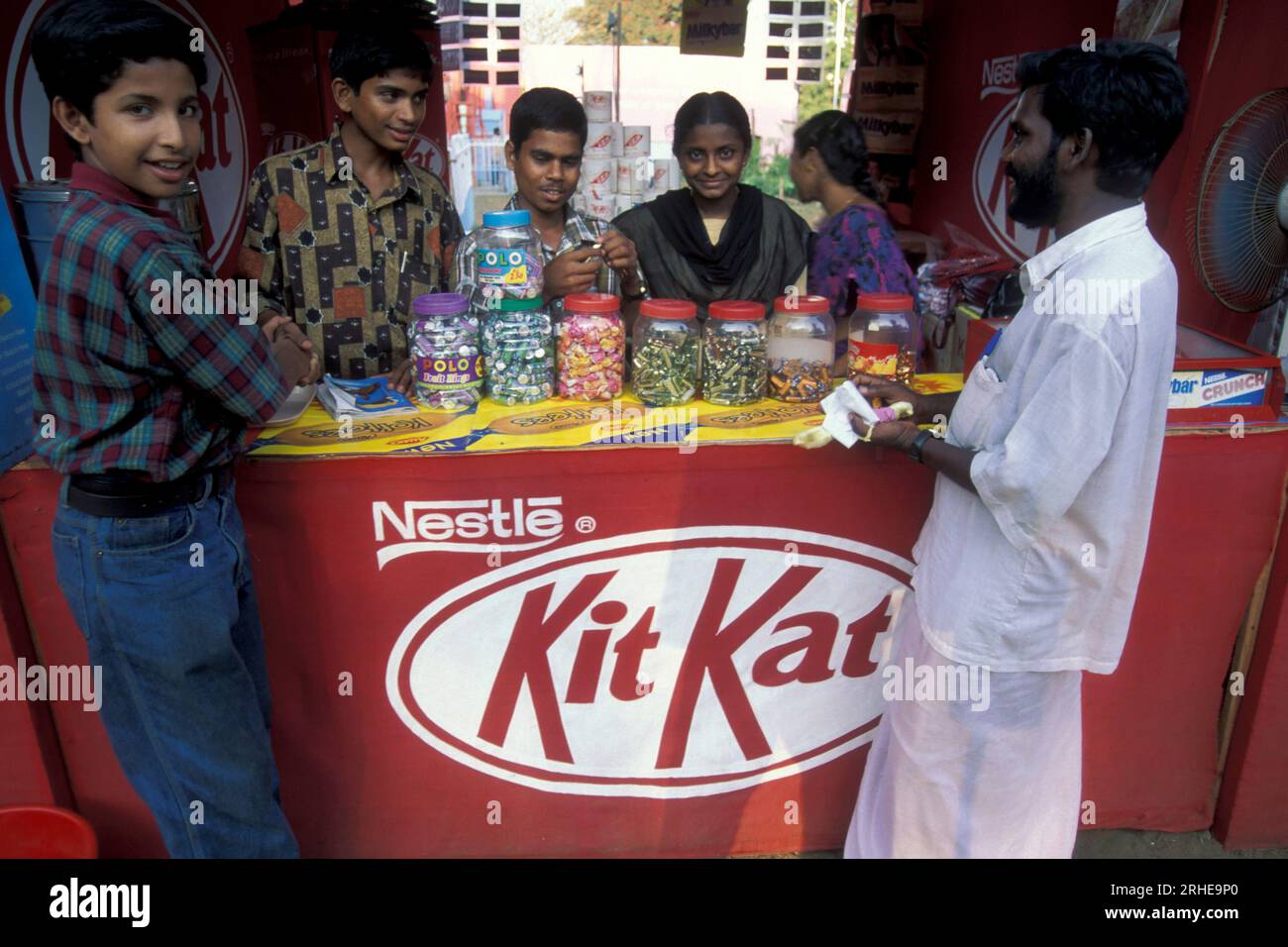 a shop of Kit Kat and sweets on a Road with Shops and Traffic in the ...