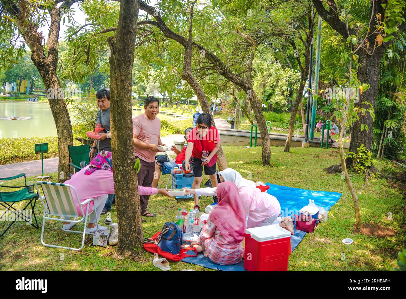 August 12, 2023. Jakarta, Indonesia. A group of people are having a picnic together under the ...