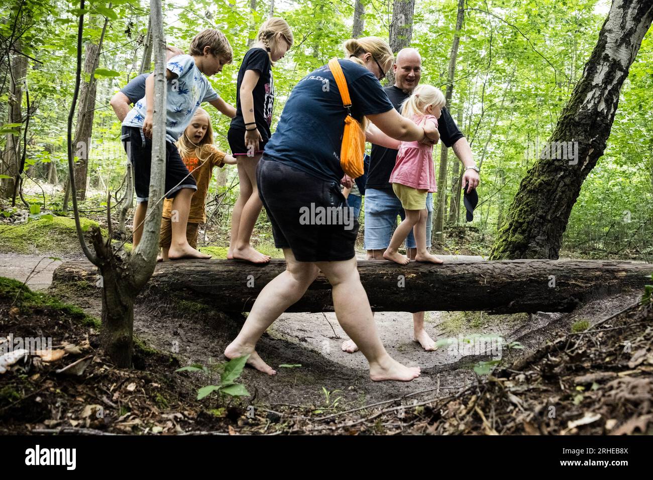 BRUNSSUM - Visitors to the barefoot park walk over various obstacles ...