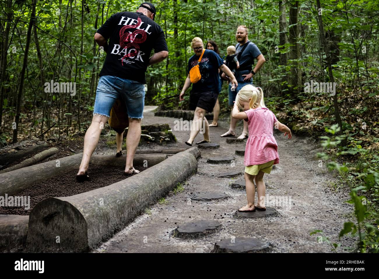 BRUNSSUM - Visitors to the barefoot park walk over various obstacles ...
