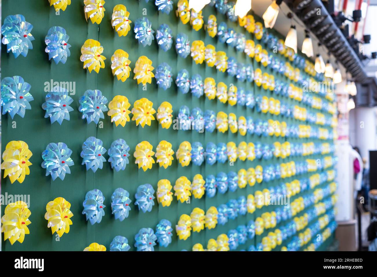 Yellow and blue plastic pinwheel decorations along a wall near Sensō-ji ...