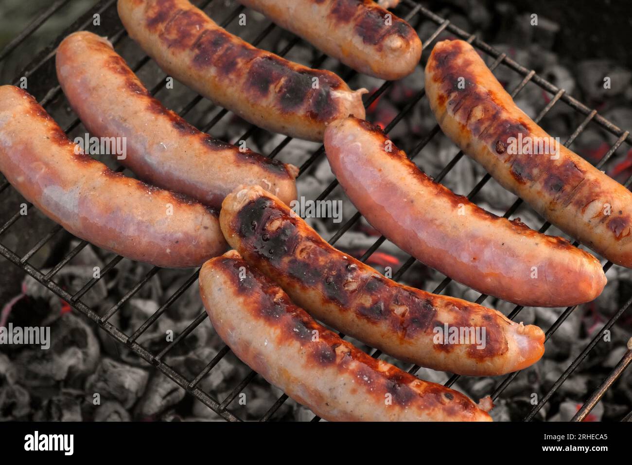 Grilled sausages. Cook man preparing grilling food bbq. Barbecue with ...