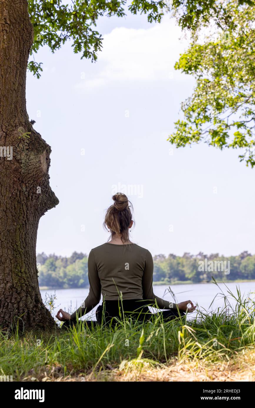 A serene and tranquil moment captured in nature, featuring a young ...