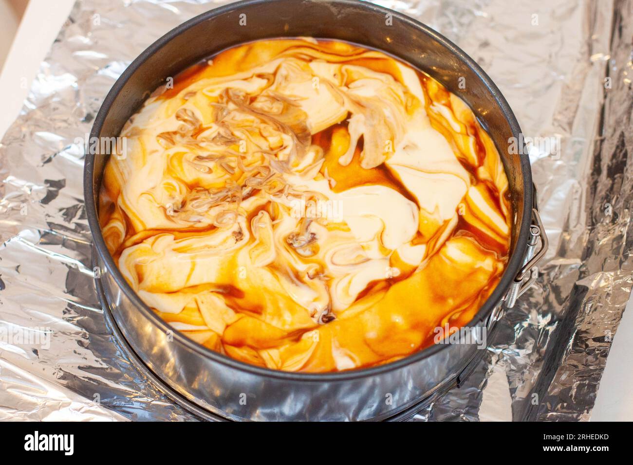Cheesecake with salted caramel before preparation. Metal baking pan ...
