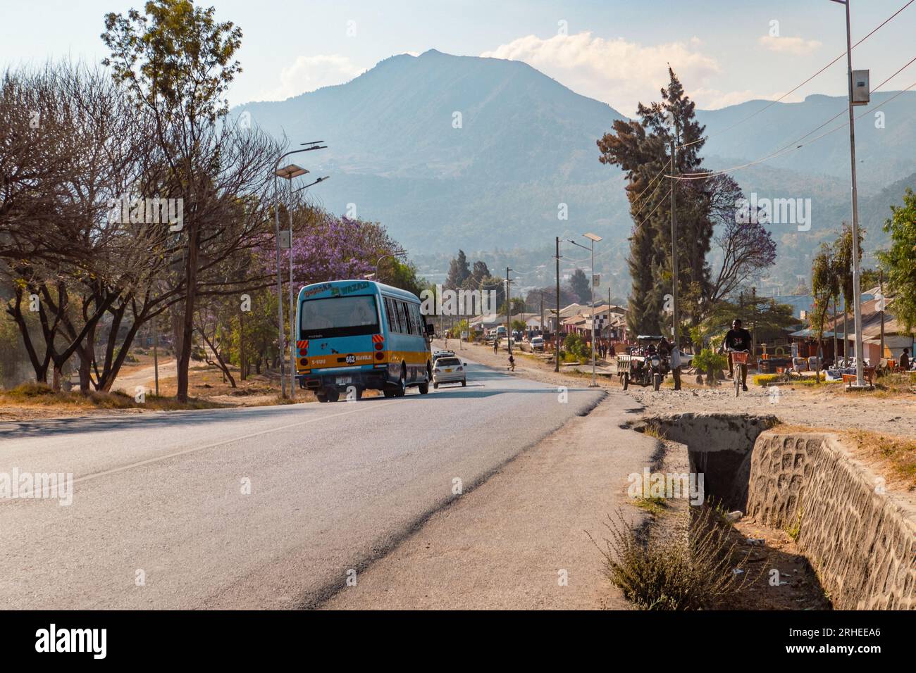 View of a dala dala bus on a busy street against the background of ...