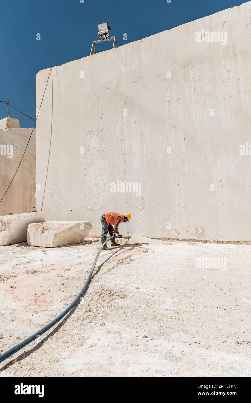 beautiful and artistic photograph of a marble mine. including men ...