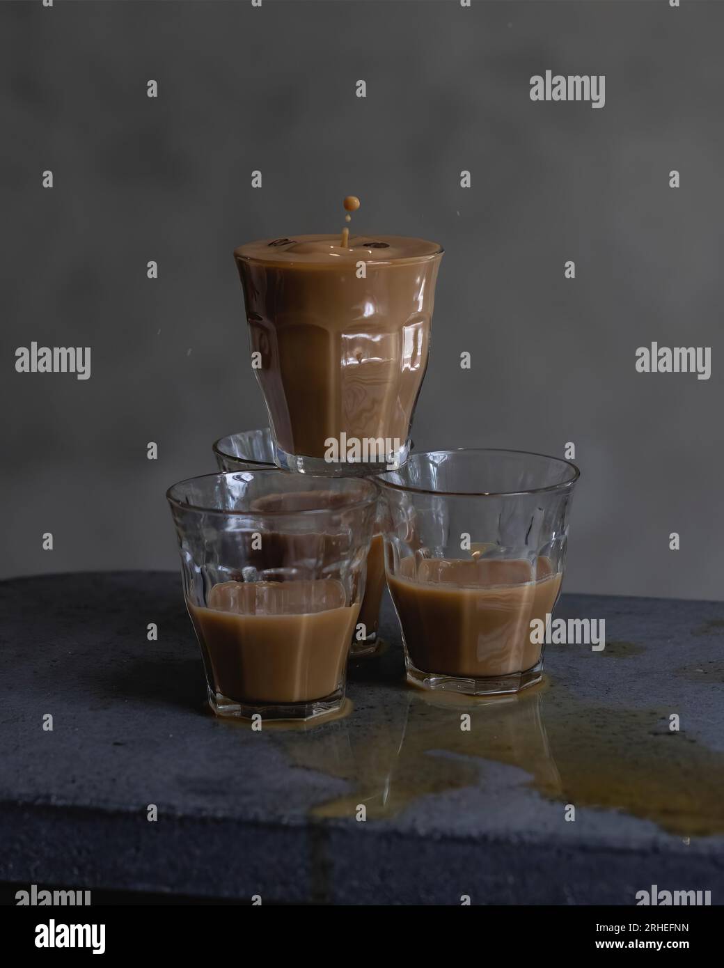 latte in glass cup that fell and spilled the latte on the table the ...