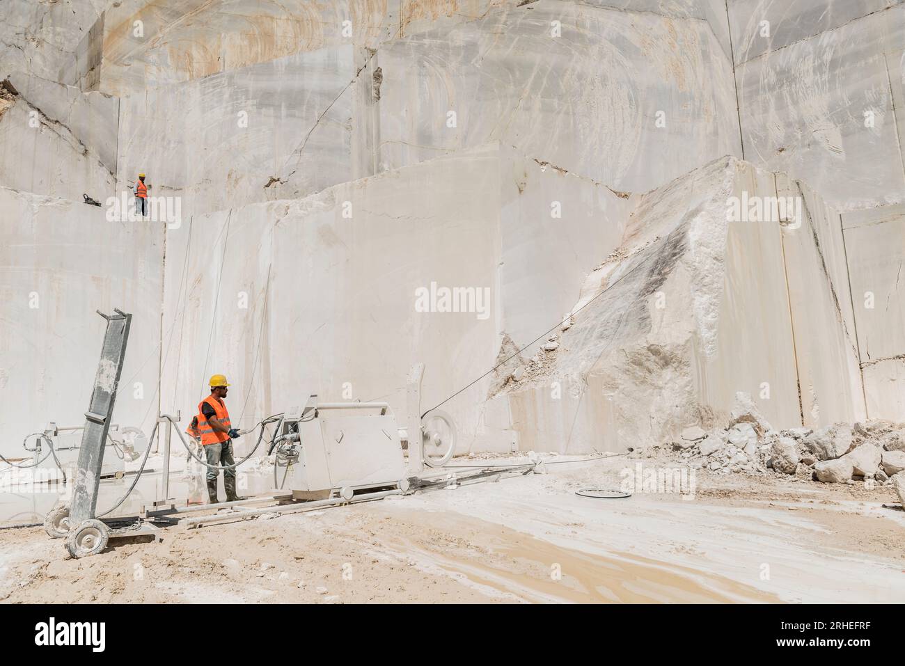 beautiful and artistic photograph of a marble mine. including men ...