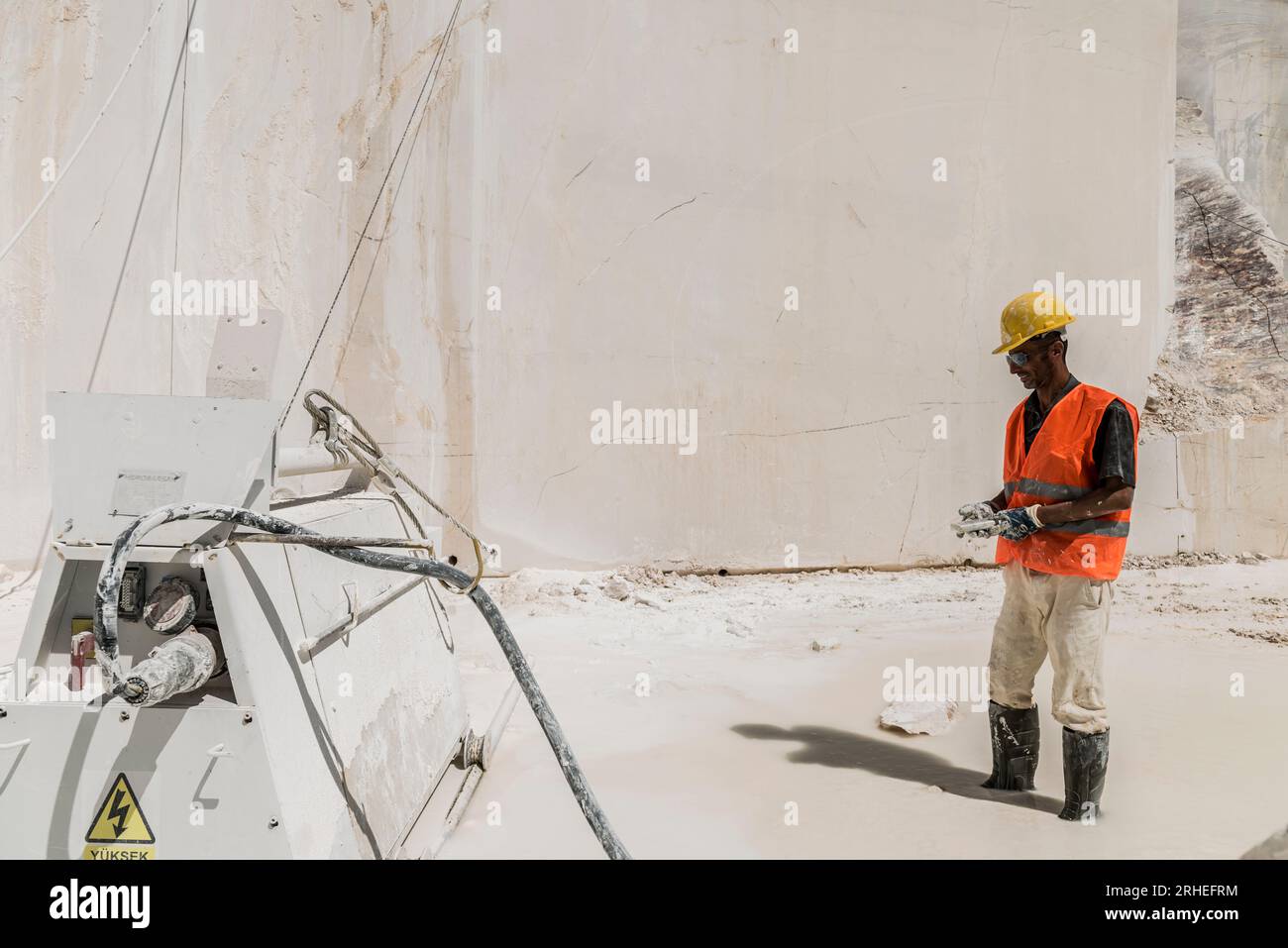 beautiful and artistic photograph of a marble mine. including men ...