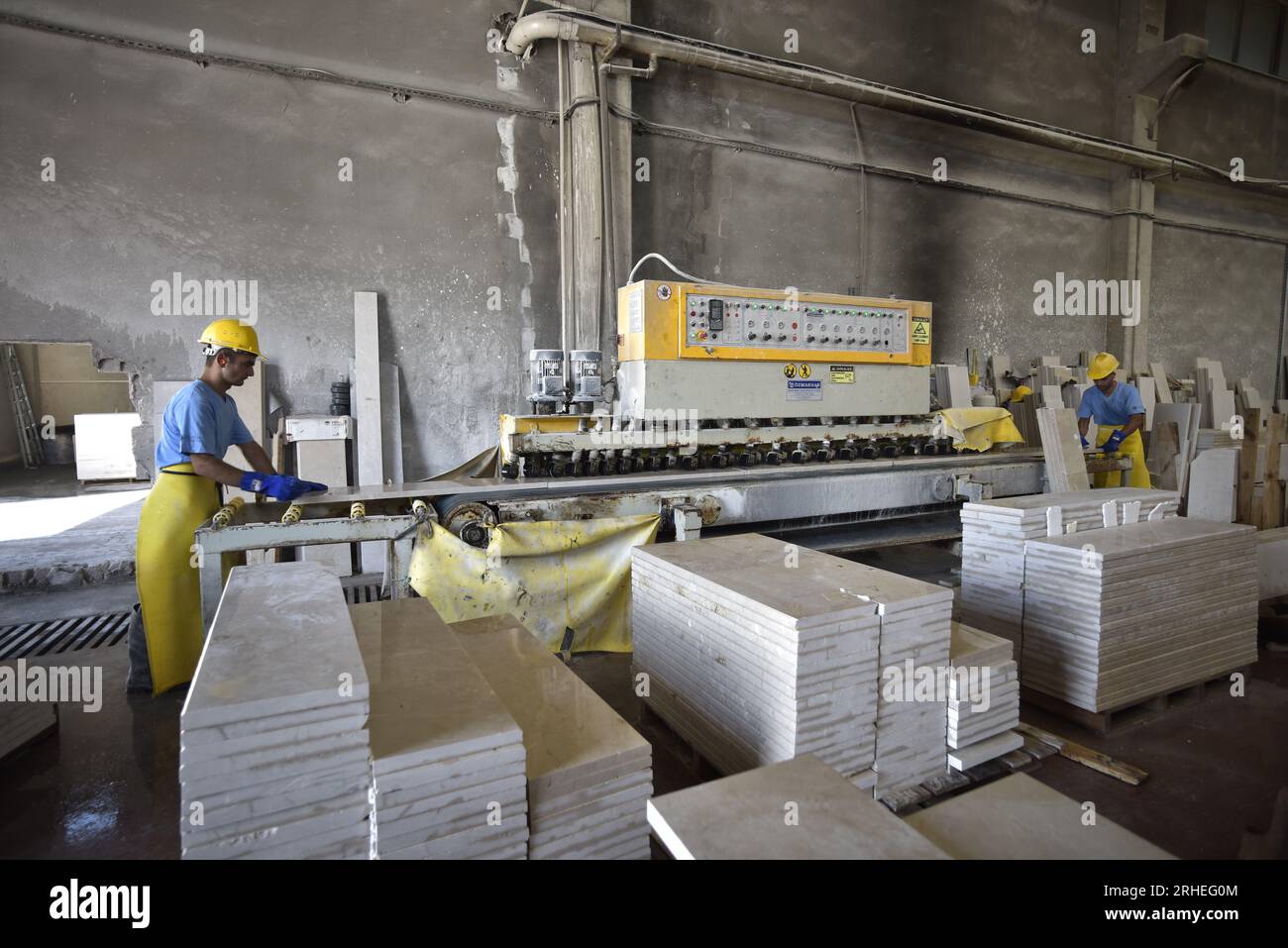 man in stone cutting factory/workshop. stone mine. marble mine ...