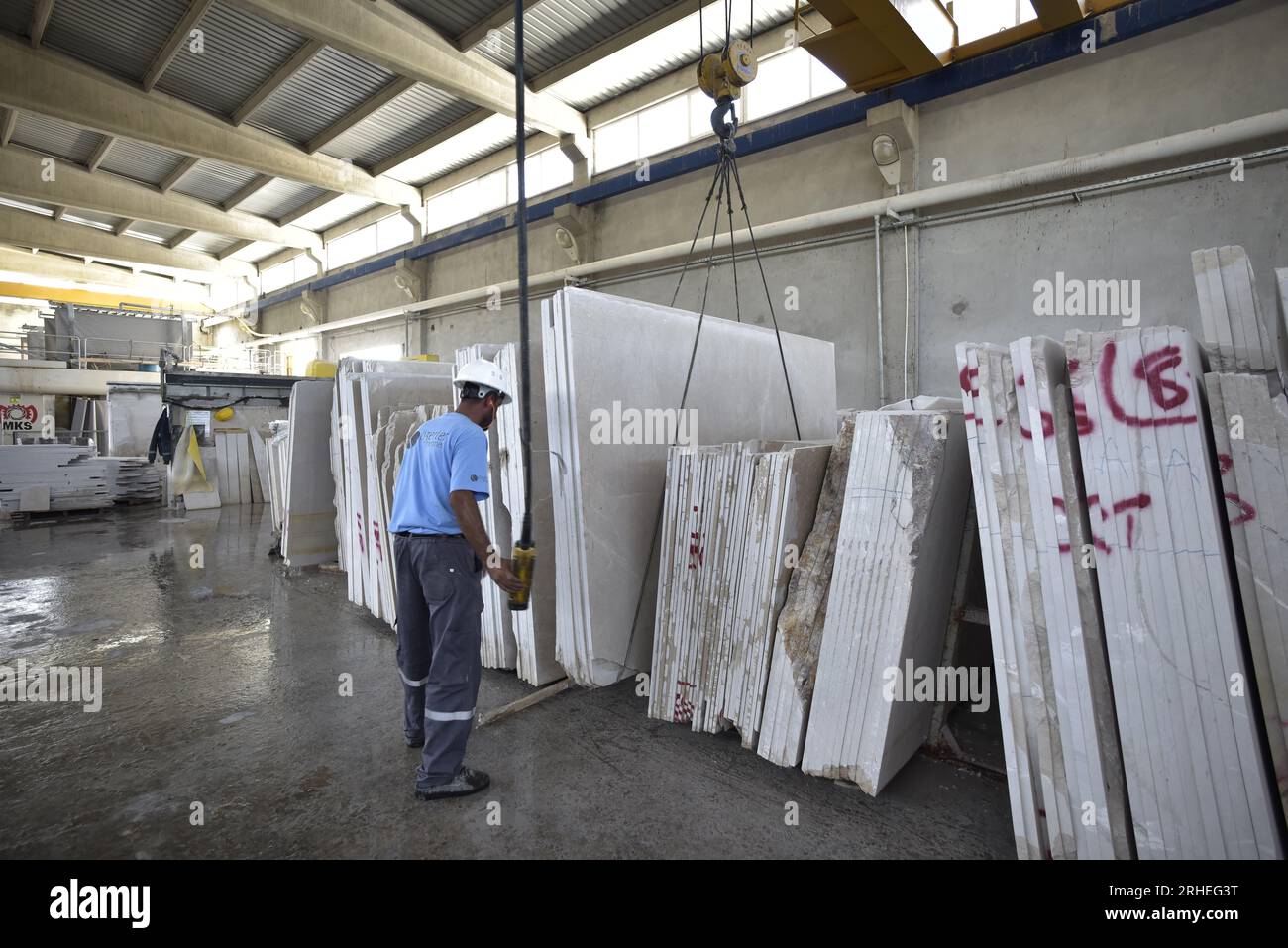 man in stone cutting factory/workshop. stone mine. marble mine ...