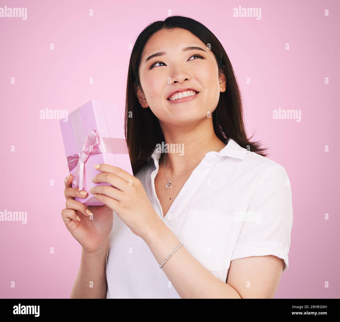 Gift, thinking and Asian woman giving present box happy for celebration ...