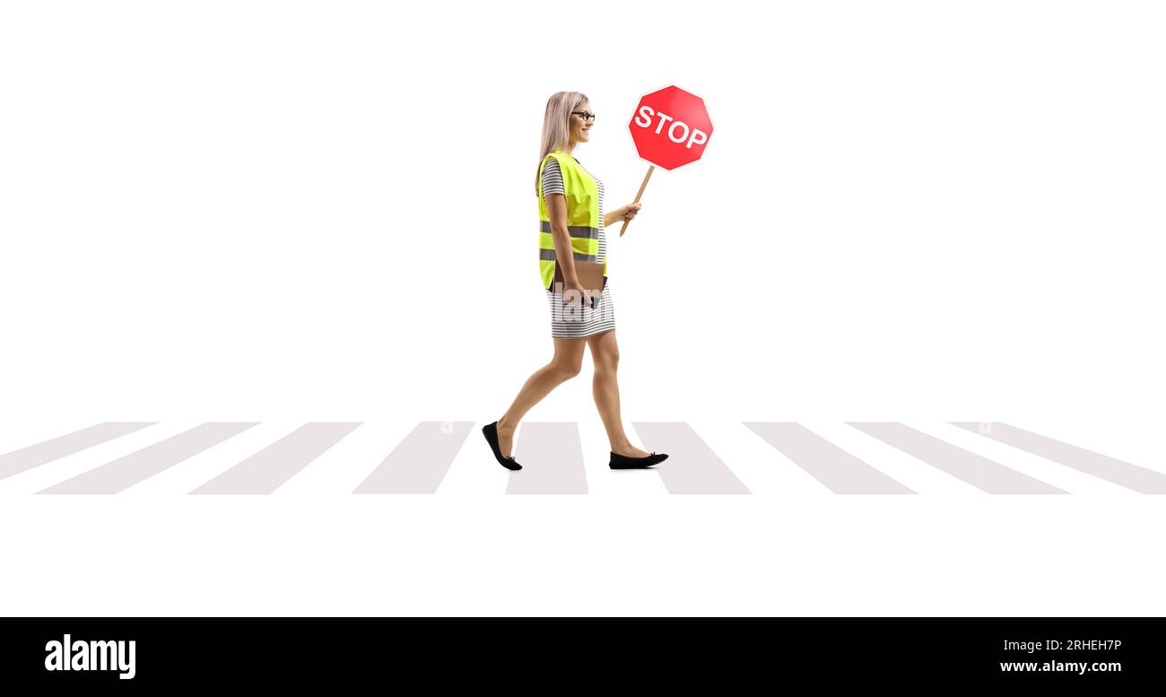 Woman with a stop sign and a safety vest crossing a street isolated on ...