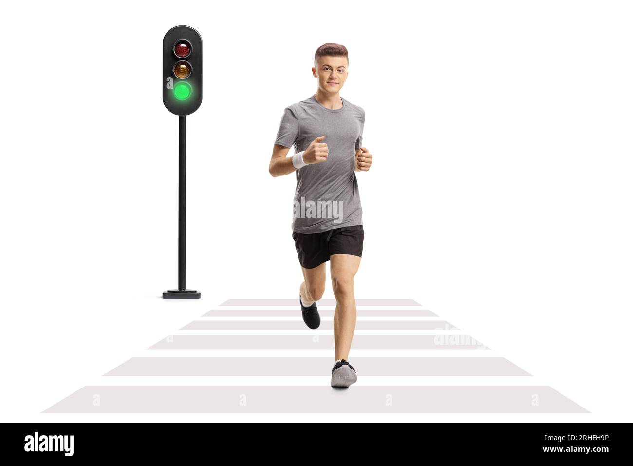 Full length portrait of a guy jogging at a pedestrian crosswalk ...