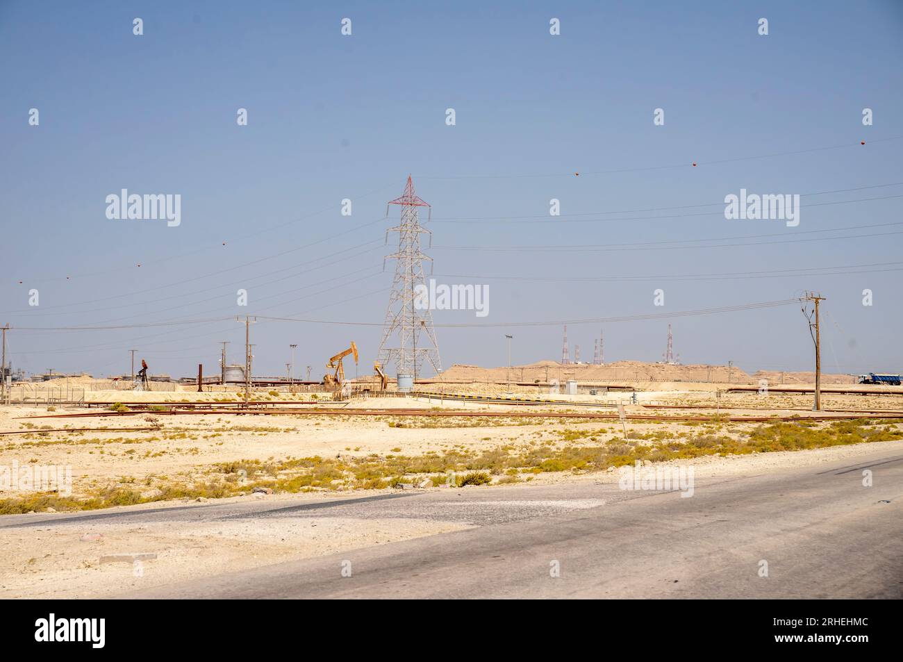 Bahrain oil field infrastructure - electric poles old and new, road ...