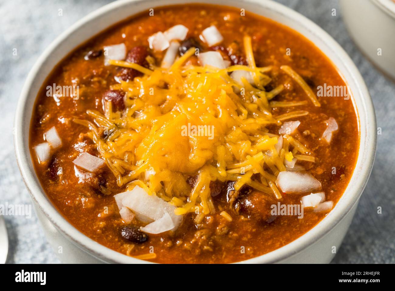 Spicy Hot Chili Con Carne with Cheese and Onions Stock Photo - Alamy