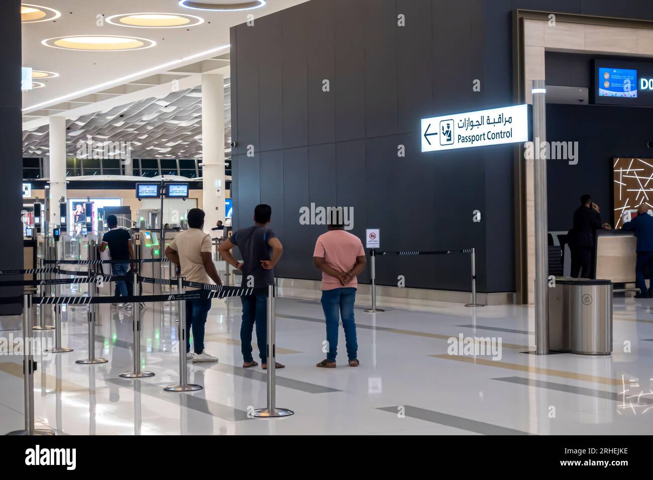 Passport control sign and check-in stands, Bahrain airport interior ...