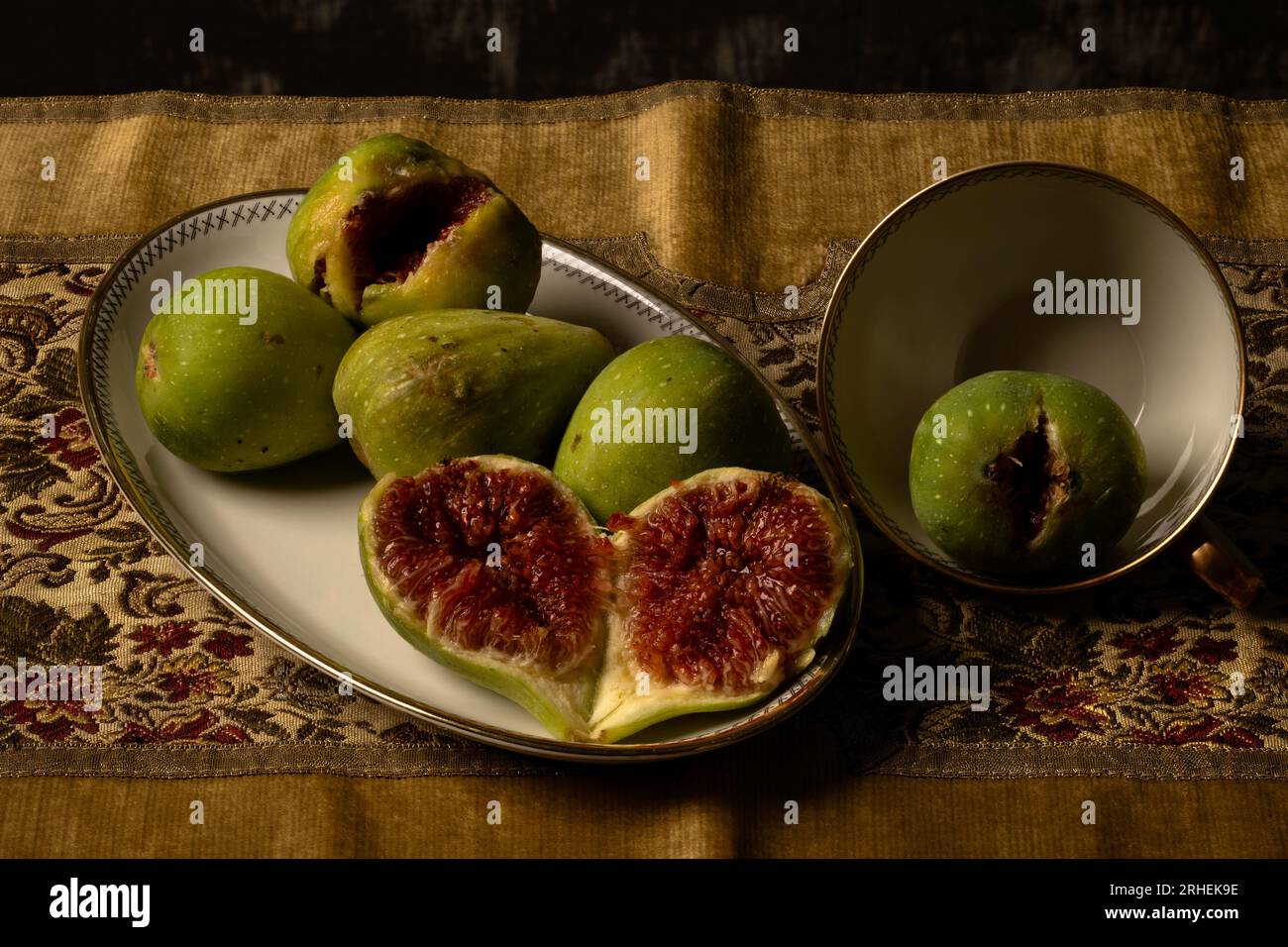a plate and a cup with figs Stock Photo - Alamy